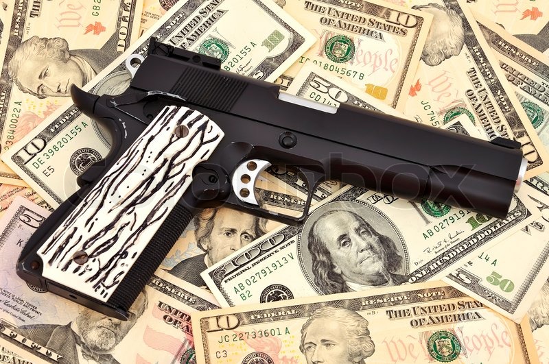 Gun and dollars | Stock Photo | Colourbox