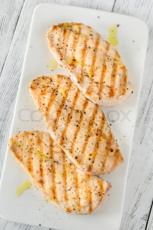 Grilled chicken on serving plate: top ... | Stock image | Colourbox