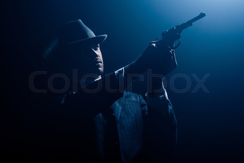 Gangster with outstretched hands aiming ... | Stock image | Colourbox