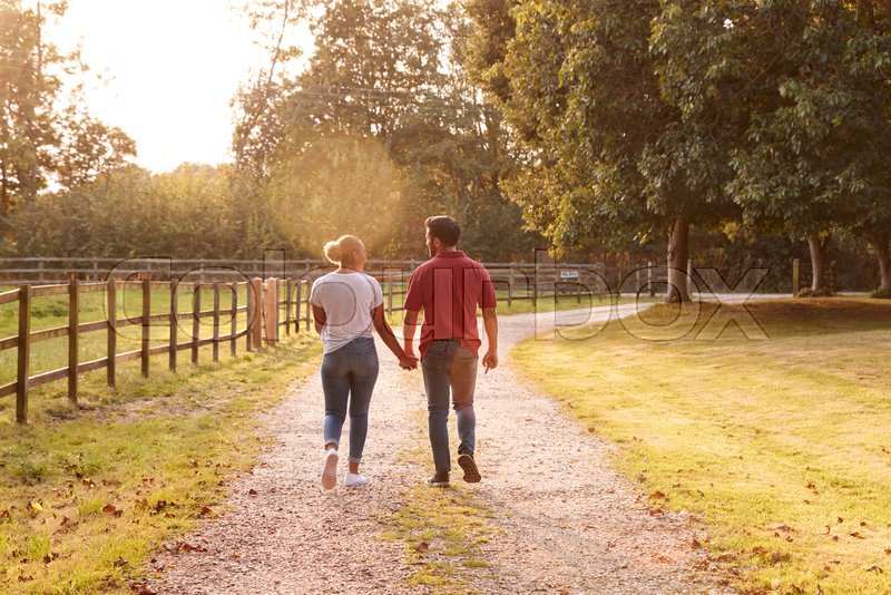 Rear View Of Romantic Couple Walking ... | Stock image | Colourbox
