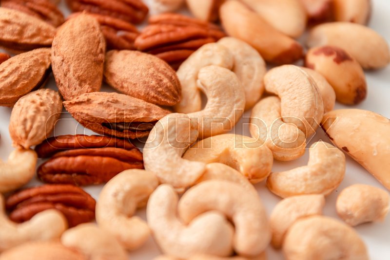 Close up assorted brown nuts on a gray ... | Stock image | Colourbox