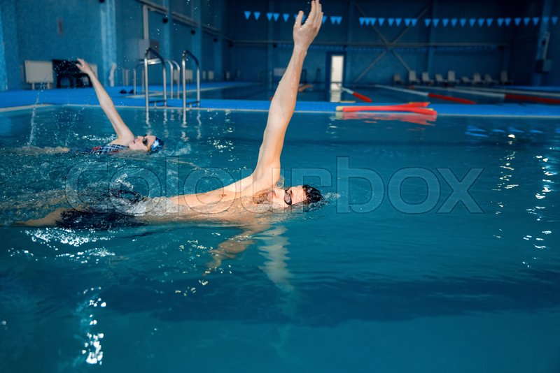 Male swimmer swims in the pool. Man and ... | Stock image | Colourbox