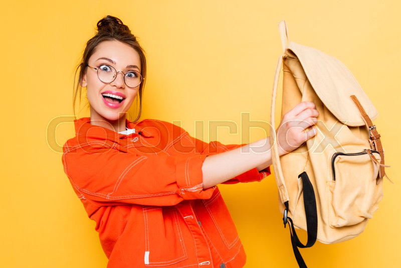 Happy student holding backpack while ... | Stock image | Colourbox