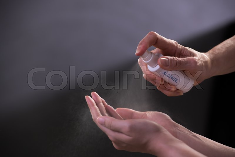 Hands spraying alcohol hand sanitizer ... | Stock image | Colourbox