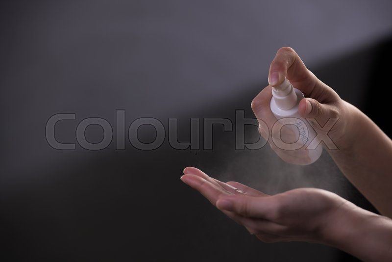 Hands spraying alcohol hand sanitizer ... | Stock image | Colourbox