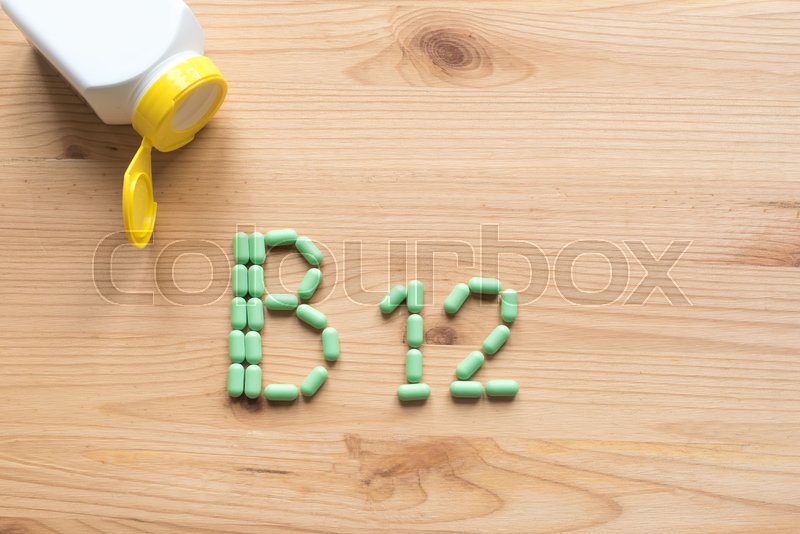 Vitamin B12. Green pills forming shape ... | Stock image | Colourbox