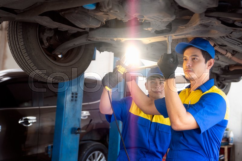 Asian man in car service, repair, ... | Stock image | Colourbox