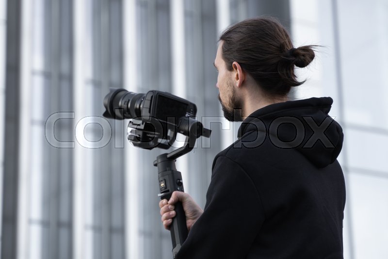 Young Professional videographer holding ... | Stock image | Colourbox