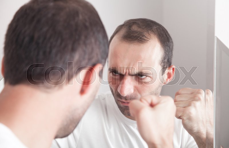 Caucasian angry man looking in mirror. | Stock image | Colourbox