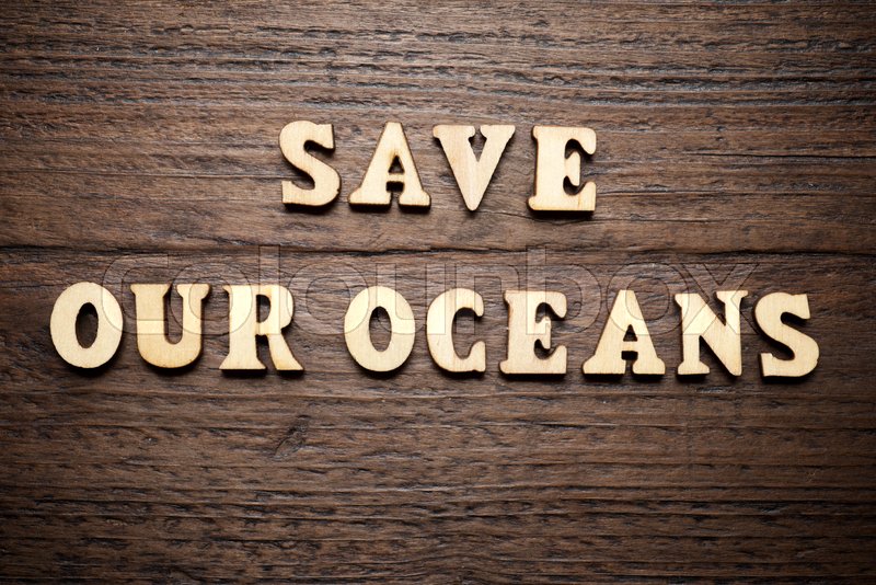 Save our oceans text on a wood table. | Stock image | Colourbox