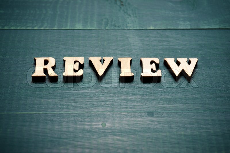 Review word on a wood table. | Stock image | Colourbox