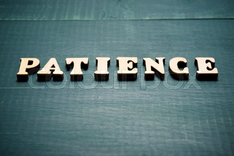 Patience word on a wood table. | Stock image | Colourbox