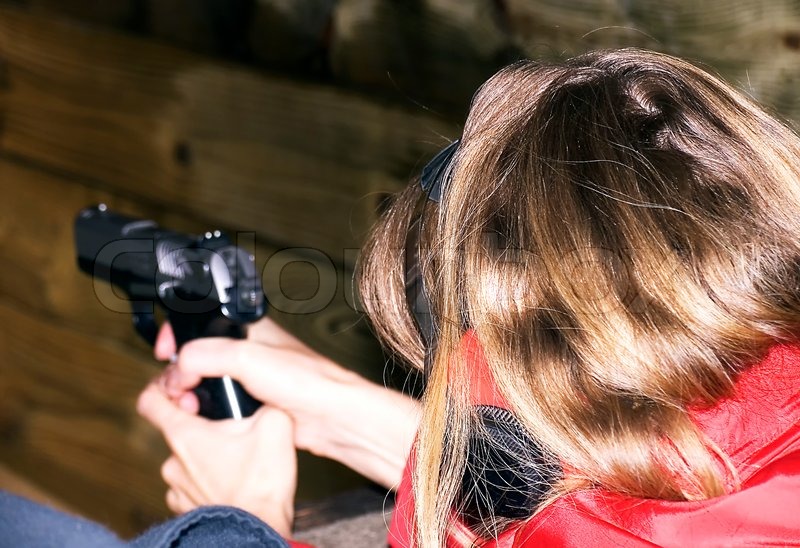 A woman target practicing with a ... | Stock Photo | Colourbox