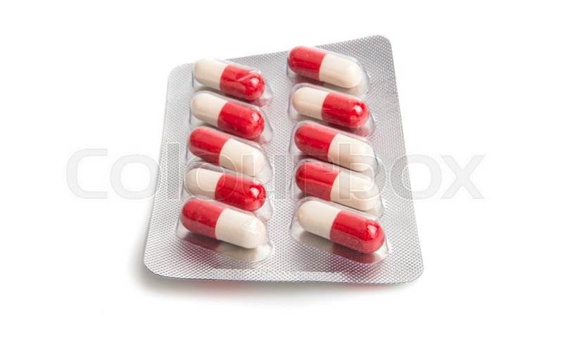 Red-white capsules isolated on white ... | Stock image | Colourbox