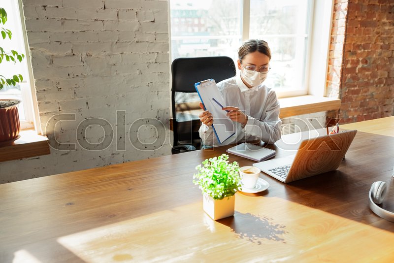 Meeting. Woman working in office alone ... | Stock image | Colourbox