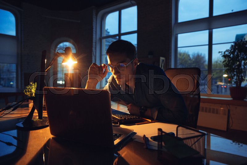 Attented. Man working in office alone ... | Stock image | Colourbox