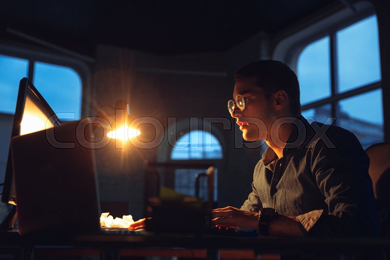 Overworked. Man working in office alone ... | Stock image | Colourbox