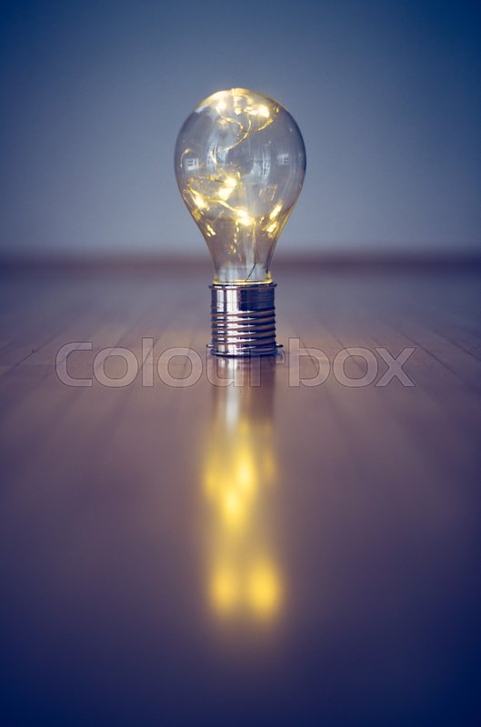 LED light bulb is lying on the wooden ... | Stock image | Colourbox