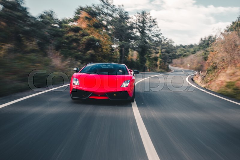 Red luxury sport car on the road,front ... | Stock image | Colourbox