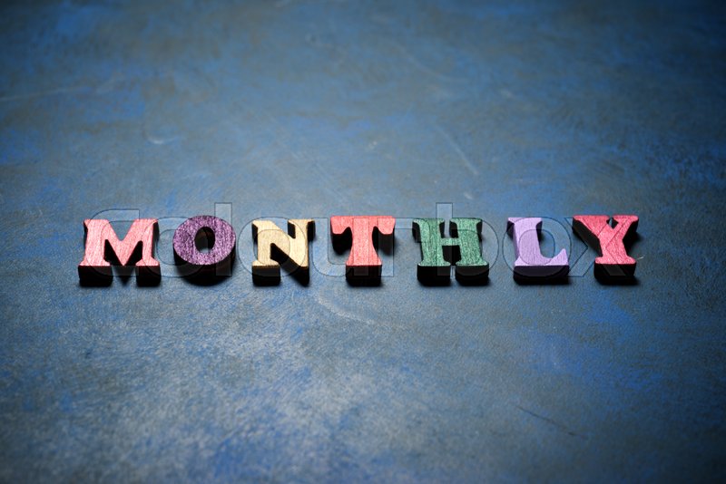 Monthly word on a blue table. | Stock image | Colourbox