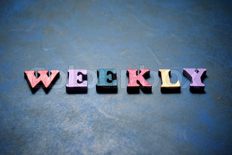 Weekly word on a blue table. | Stock image | Colourbox