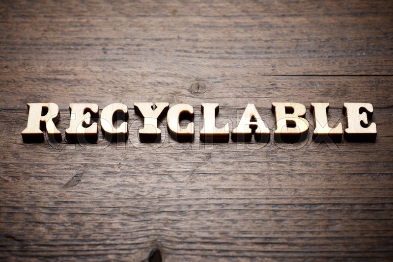 Recyclable word on a wood table. | Stock image | Colourbox
