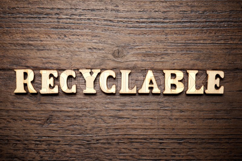 Recyclable word on a wood table. | Stock image | Colourbox