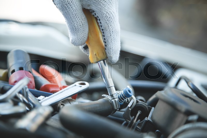 Mechanic holding screwdriver. Auto ... | Stock image | Colourbox