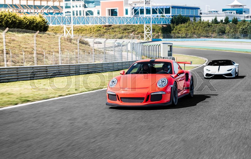 Red and white sport cars racing with ... | Stock image | Colourbox