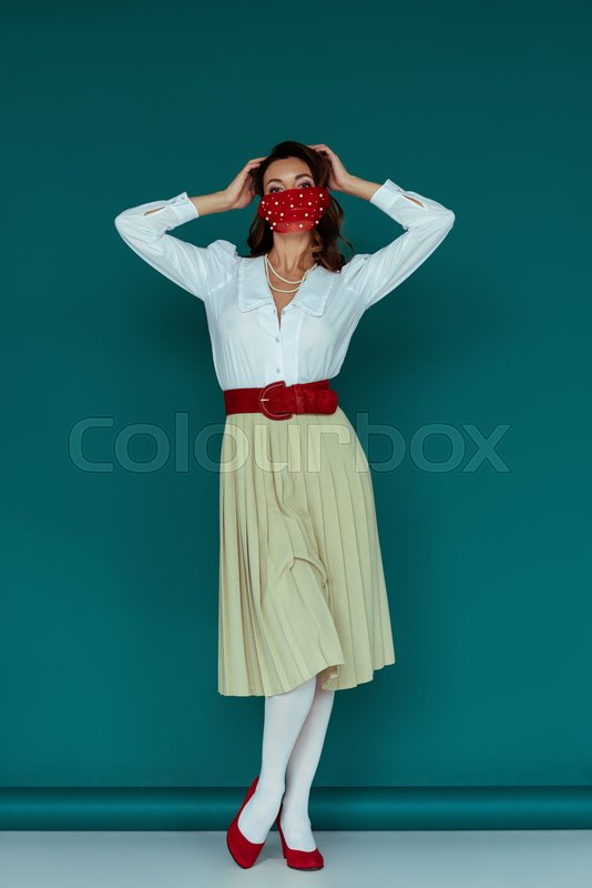 Stylish young woman in red mask ... | Stock image | Colourbox