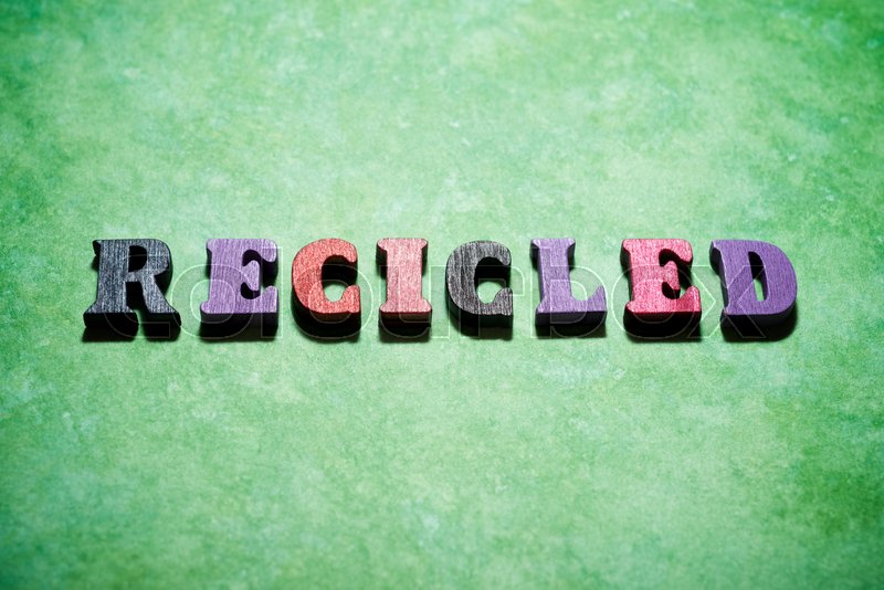 Recycled word on a green paper. | Stock image | Colourbox