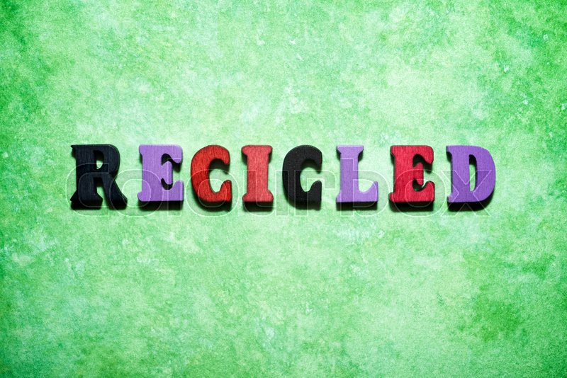 Recycled word on a green paper. | Stock image | Colourbox