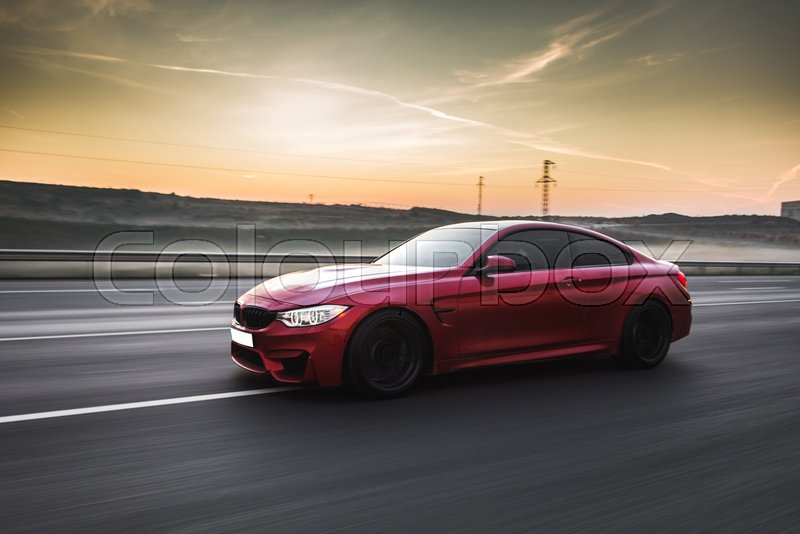 Red racing car in the sunset, ... | Stock image | Colourbox