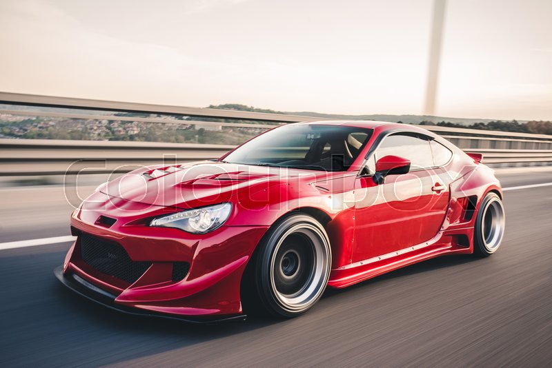 Red racing car on the highway with ... | Stock image | Colourbox