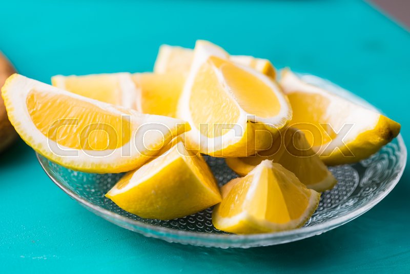 Lemon wedges on the plate - lemon ... | Stock image | Colourbox