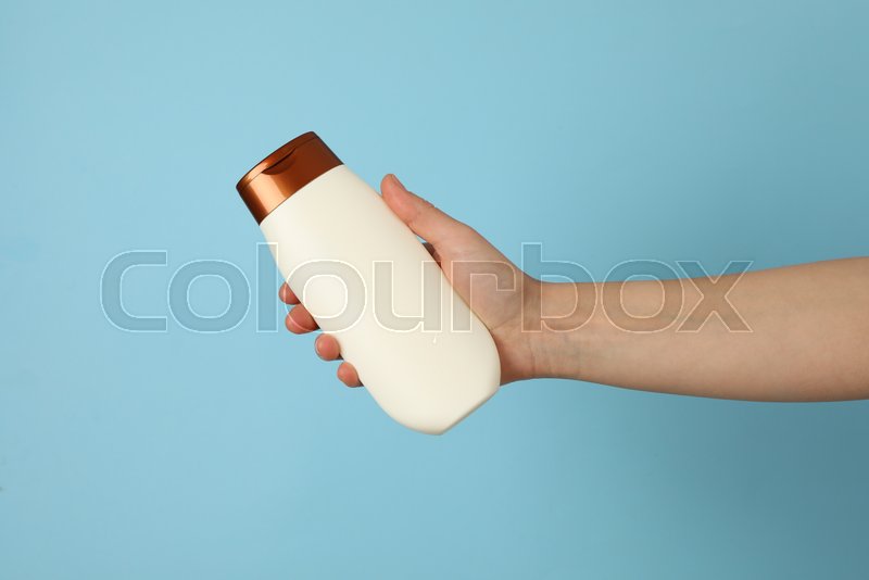 Female hand holds shampoo bottle on ... | Stock image | Colourbox