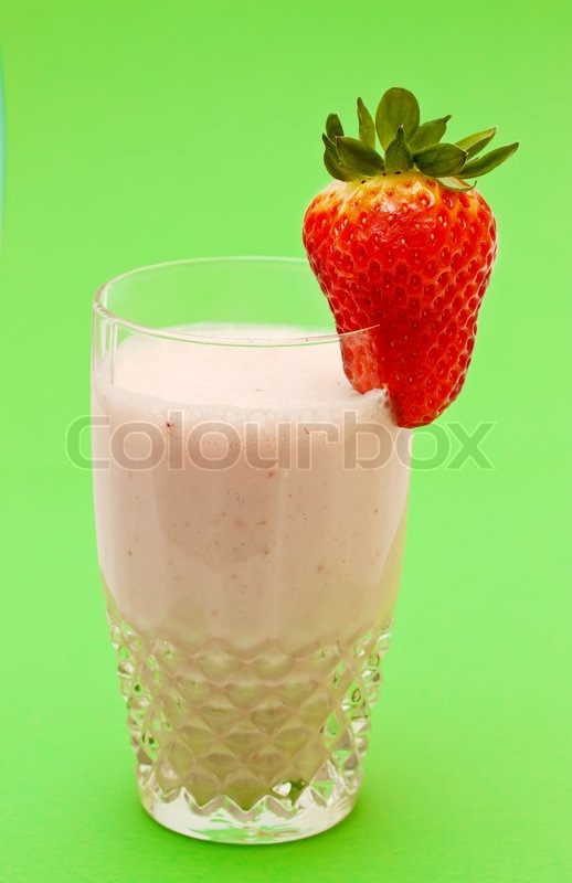 Strawberry milkshake on a green ... | Stock image | Colourbox