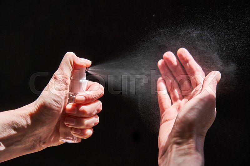 Human hand spraying sanitizer over ... | Stock image | Colourbox