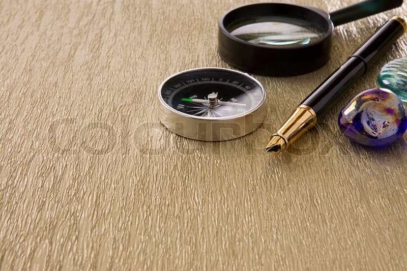 Compass, ink pen and magnifier on gold ... | Stock image | Colourbox