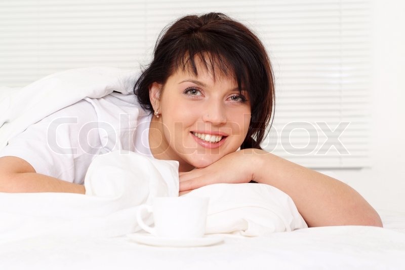 Beautiful woman lying in bed | Stock image | Colourbox