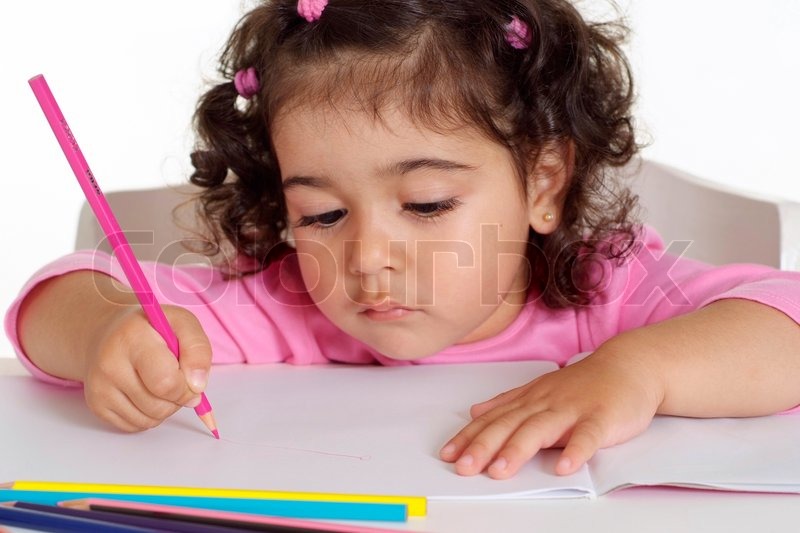 Good-looking little girl draws | Stock image | Colourbox