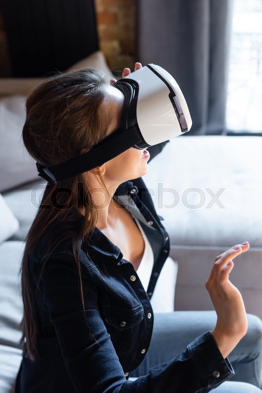 Young woman in virtual reality headset ... | Stock image | Colourbox