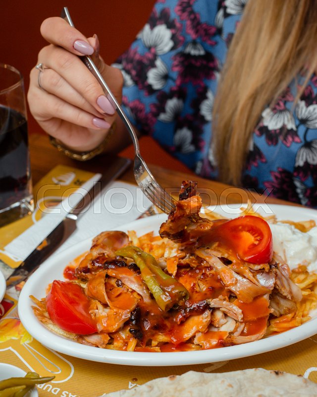 Women eating roasted chicken pieces ... | Stock image | Colourbox