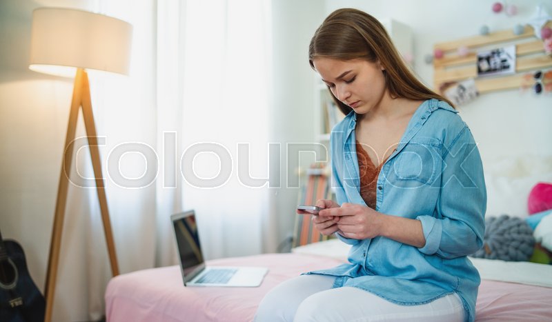 Sad and worried young girl with laptop ... | Stock image | Colourbox
