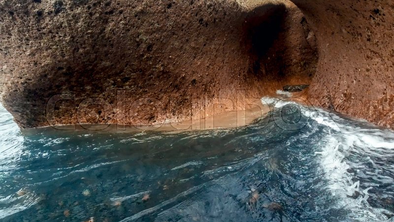 Sea waves splashing in the cave at high ... | Stock image | Colourbox