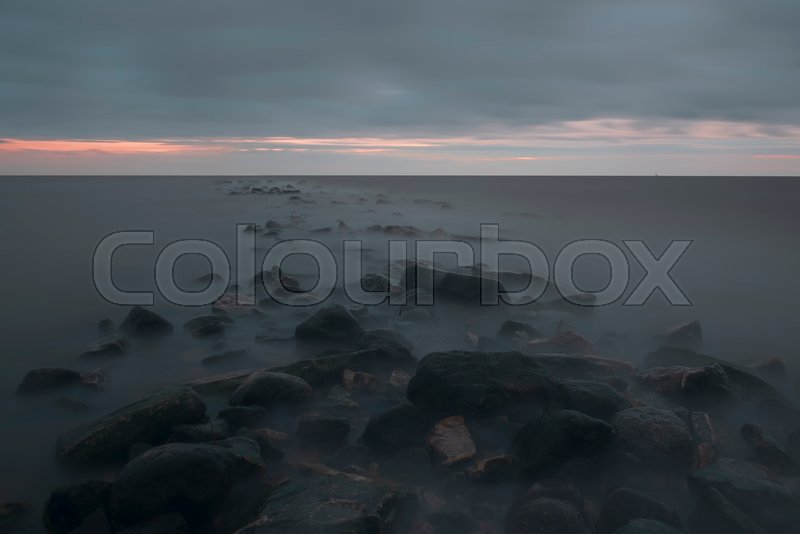 Mystical foggy sea and rocky shore in ... | Stock image | Colourbox