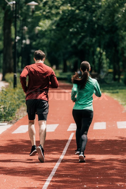 Back view of couple running on running ... | Stock image | Colourbox