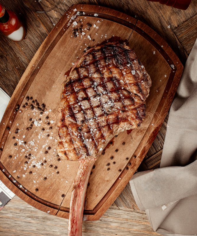Grilled boneless steak on a wooden ... | Stock image | Colourbox