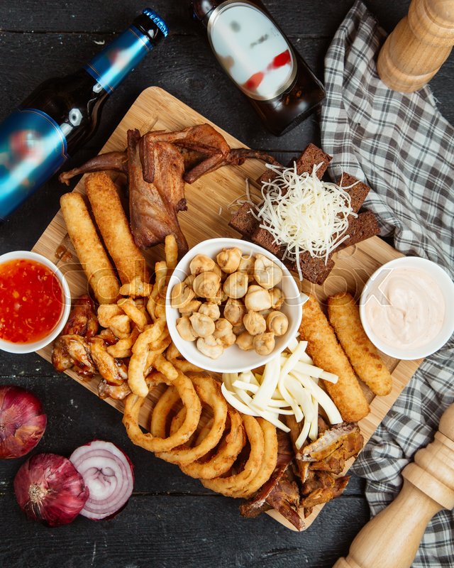 Beer set with various snacks on the ... | Stock image | Colourbox