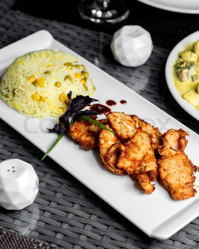 A platter of rice with peas served with ... | Stock image | Colourbox